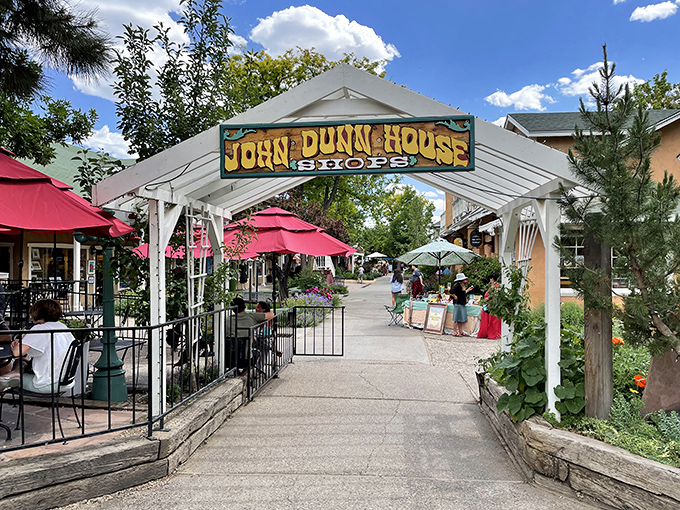 The John Dunn Shops welcome visitors with shade, flowers, and the promise of treasures that won't be found in any mall back home.