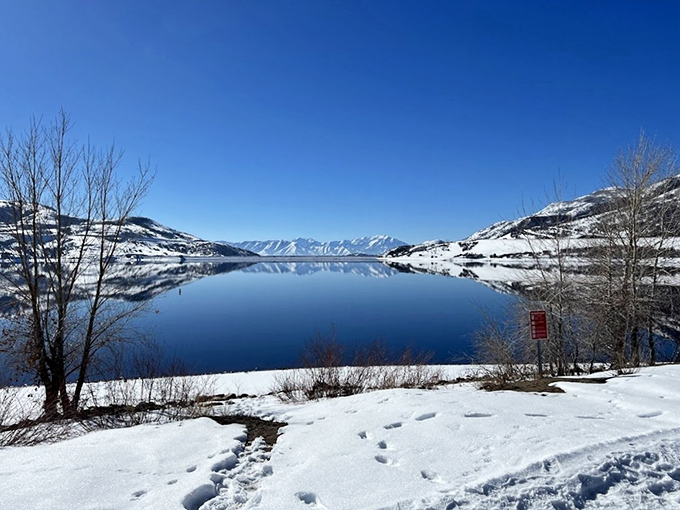 Winter wonderland mode activated &ndash; when the reservoir becomes a mirror reflecting snow-capped peaks in stunning symmetry.