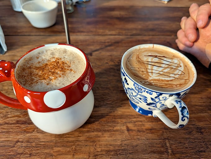 Coffee artistry in mismatched mugs &ndash; one dotted with whimsy, one painted with tradition. Both delivering the caffeine gospel we so desperately need. 