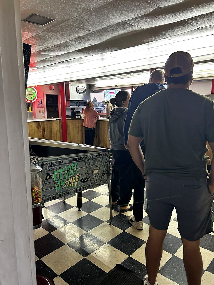 The classic black and white checkered floor leads moviegoers to concession counter treasures&mdash;a ritual as important as the film itself.
