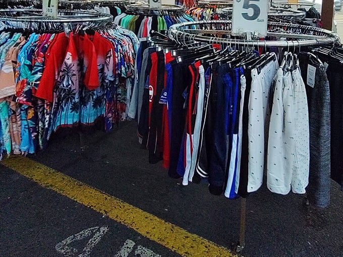 The clothing carousel of sports loyalties. Eagles, Giants, and vintage team gear hanging like neighborhood allegiances on full display.