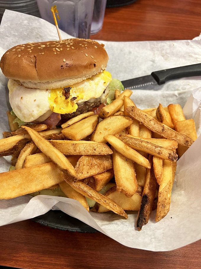 A burger that requires both hands and a strategy. Those hand-cut fries aren't just sides &ndash; they're co-stars in this delicious production.