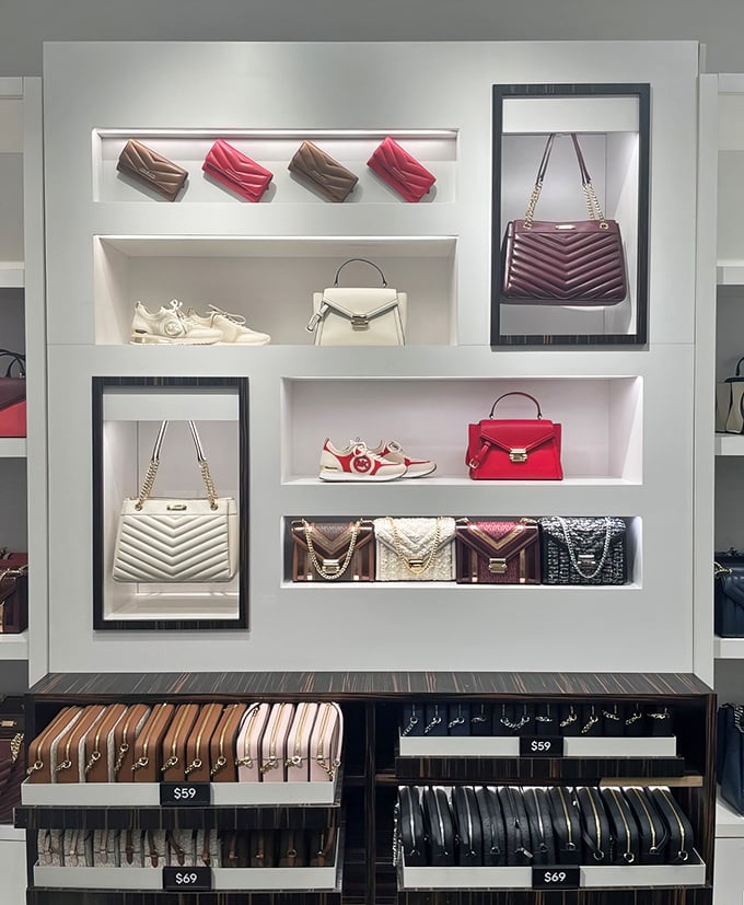 Michael Kors display wall&mdash;where handbags are arranged with the reverence of museum pieces, but priced for actual humans to purchase.