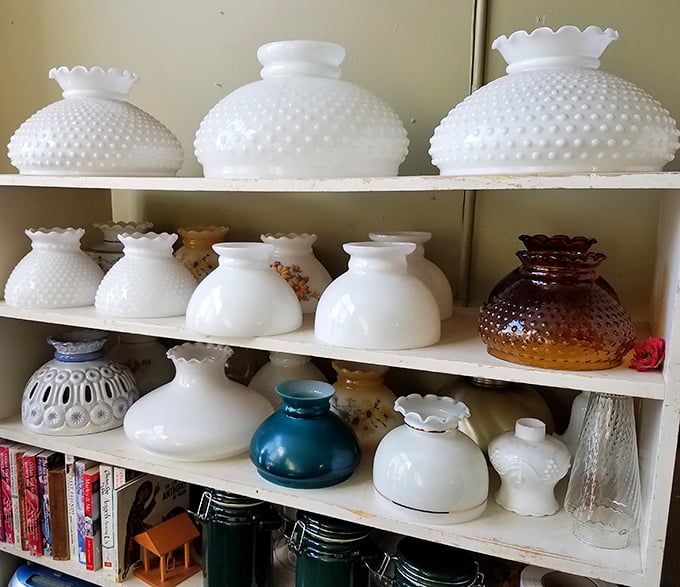 Hobnail milk glass lampshades that once illuminated mid-century living rooms now wait for their second act. Grandma would approve of this collection.