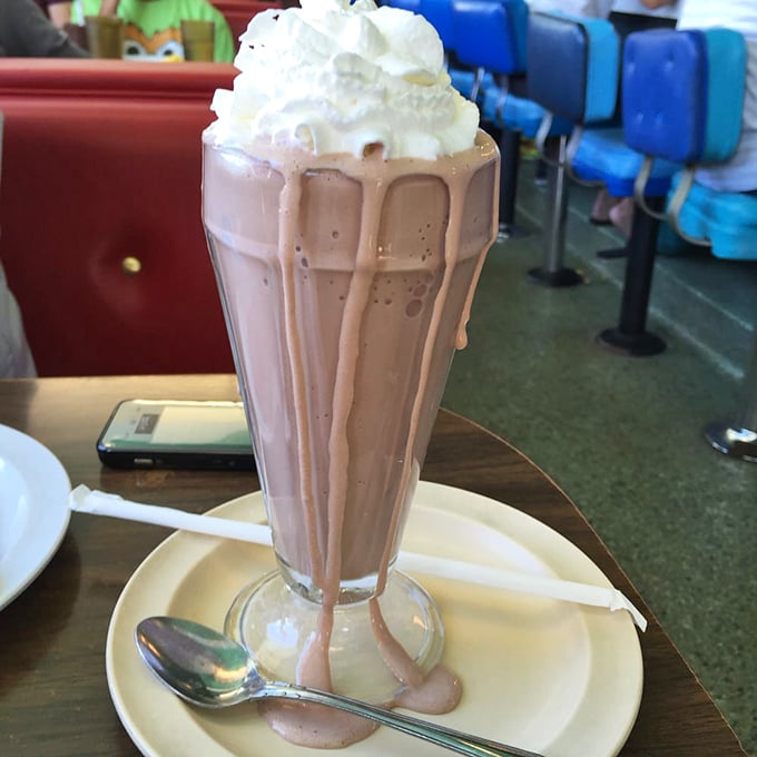 A chocolate milkshake topped with whipped cream, served in a classic fountain glass that Instagram wasn't ready for but desperately needed.