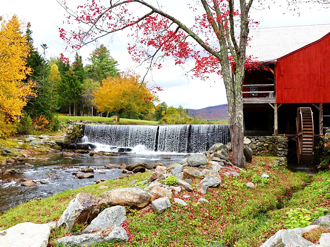 Fall foliage frames this waterfall and red mill like nature decided to create the perfect New England postcard just for passing travelers.