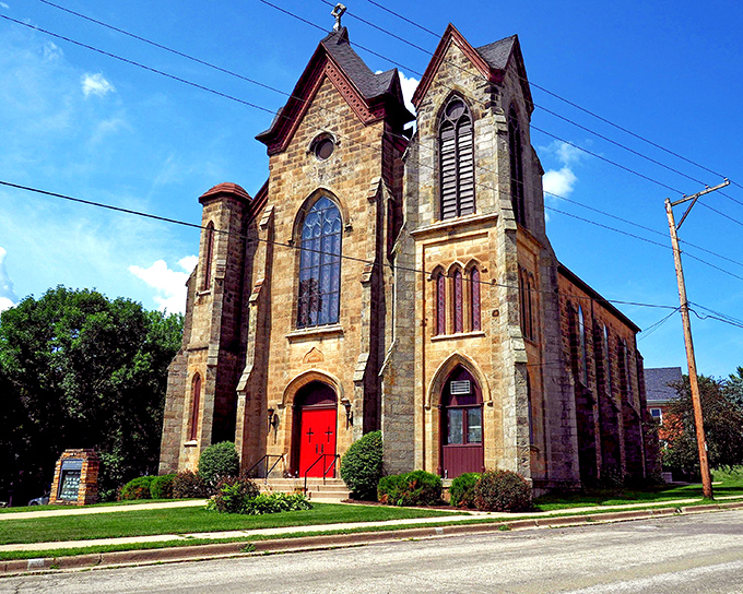 The Methodist Church's honey-colored limestone and Gothic windows create a postcard-perfect scene that hasn't changed in over a century.