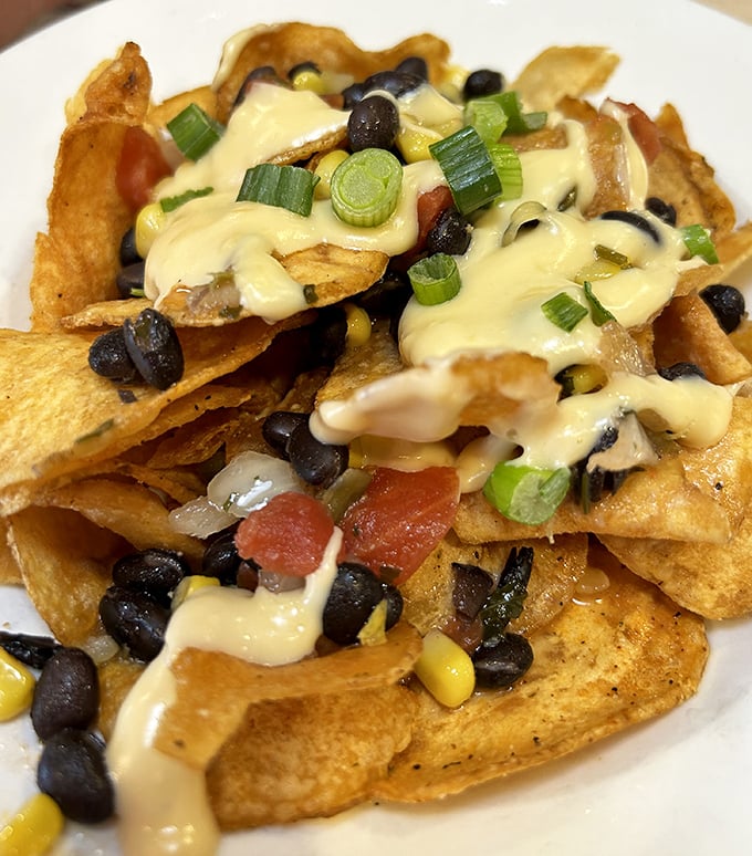 These loaded nachos aren't just an appetizer&mdash;they're an architectural achievement of crispy chips, black beans, and cheese that flows like delicious lava.