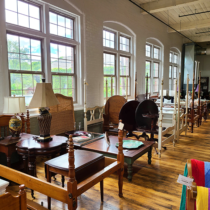 Those towering windows flood the space with natural light, making each four-poster bed and side table look ready for its close-up.