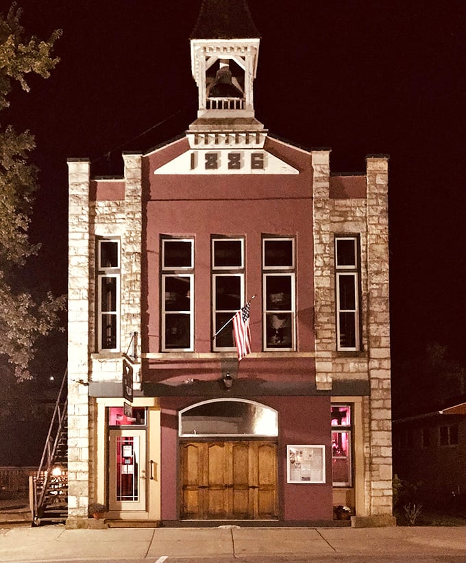 The Old Village Hall Restaurant glows at night like a lighthouse for the hungry. Those limestone accents aren't architecture&mdash;they're character lines on a familiar face.