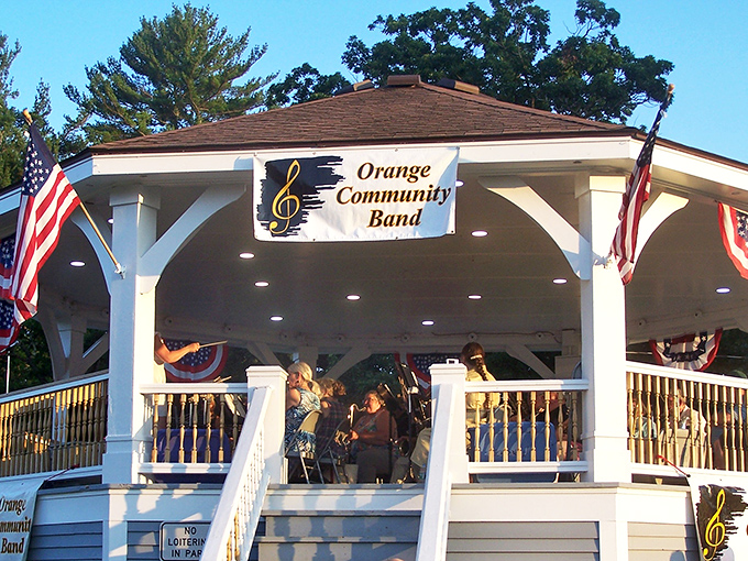 The Orange Community Band performs under their gazebo, delivering concerts that won't bankrupt your entertainment budget completely.