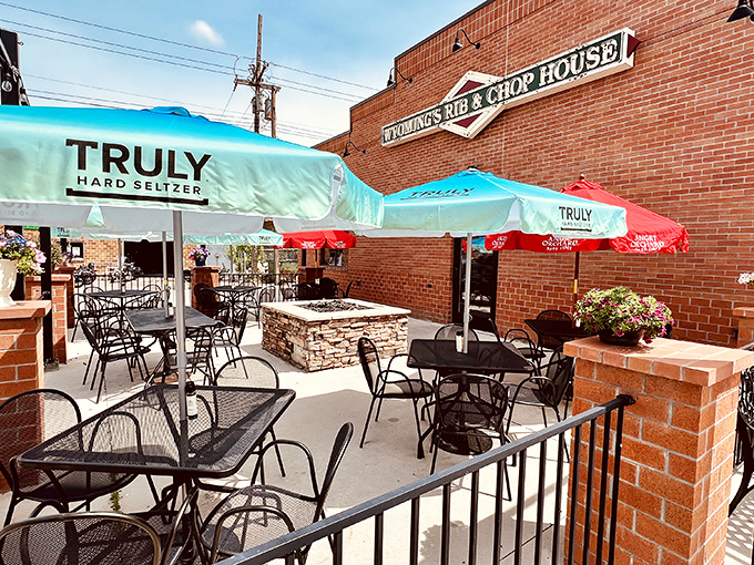 The patio at Wyoming's Rib & Chop House &ndash; where summer evenings, cold drinks, and the promise of meat unite under cheerful umbrellas.