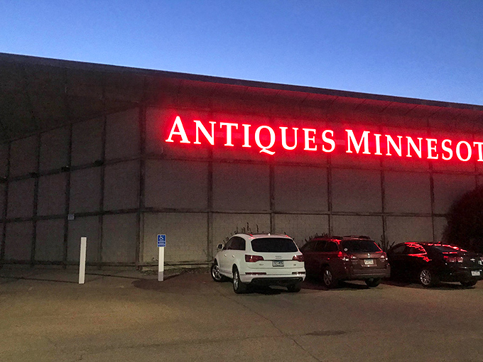 As night falls, the neon glow transforms this concrete box into a lighthouse for night-owl collectors seeking vintage shores.