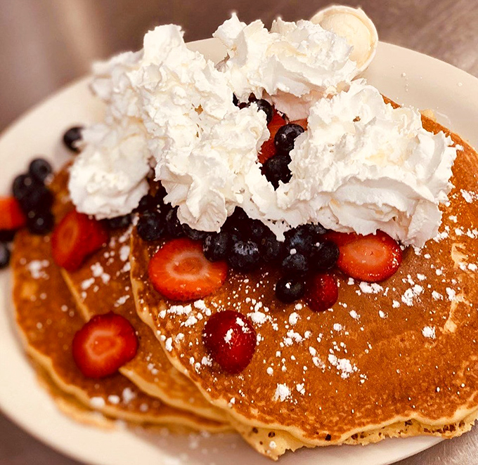 These pancakes, crowned with berries and whipped cream, aren't just breakfast &ndash; they're an edible work of art that happens to taste like childhood joy.