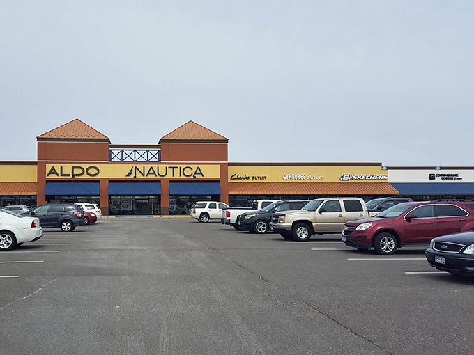The parking lot fills with cars belonging to people who understand that discount shopping requires commitment and good footwear.