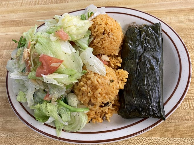 The pastele plate&mdash;a Puerto Rican treasure wrapped in island hospitality. That orange rice isn't messing around either.
