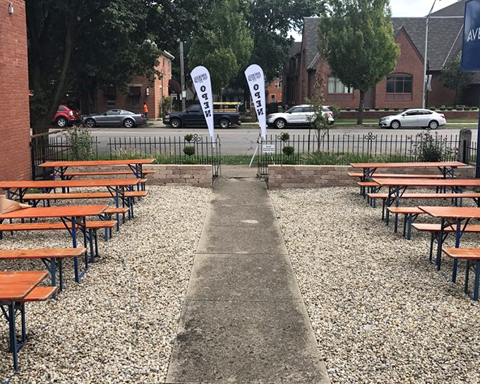 The outdoor seating area—where fresh air meets fresh barbecue. Those "Open" flags aren't just announcements—they're celebrations.