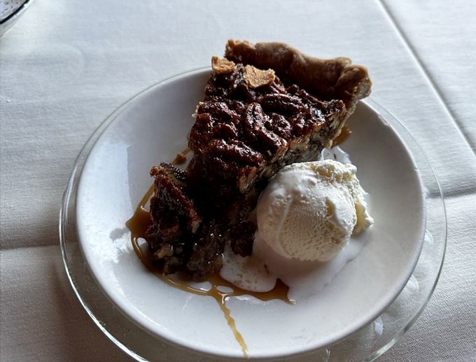 Pecan pie that strikes the perfect balance between gooey and crunchy, warm and cool. The scoop of vanilla ice cream is melting with excitement.