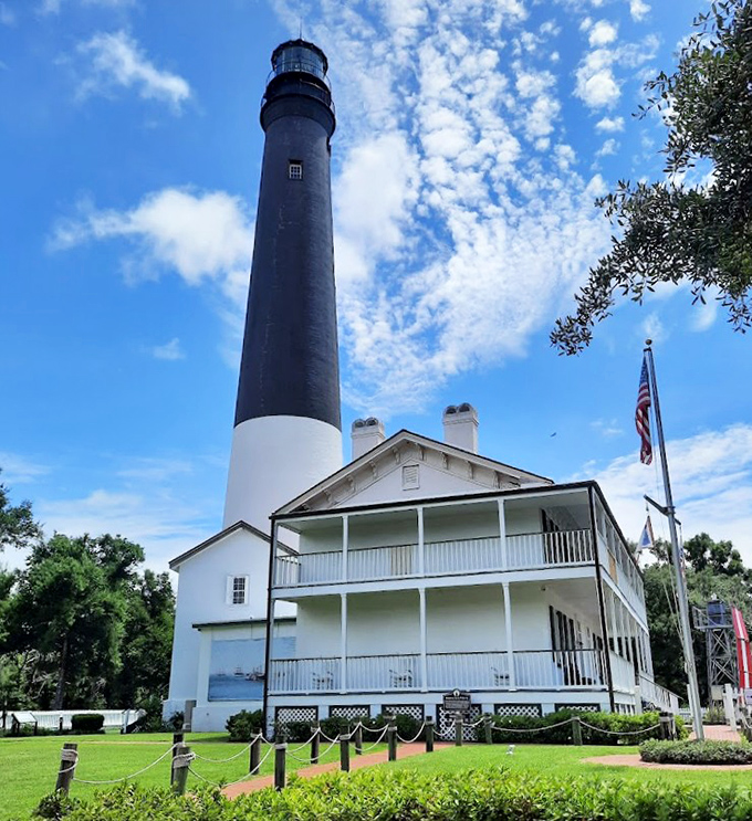 The Pensacola Lighthouse stands tall against Gulf skies &ndash; a 177-foot reminder that some of the best views require climbing 177 steps first.