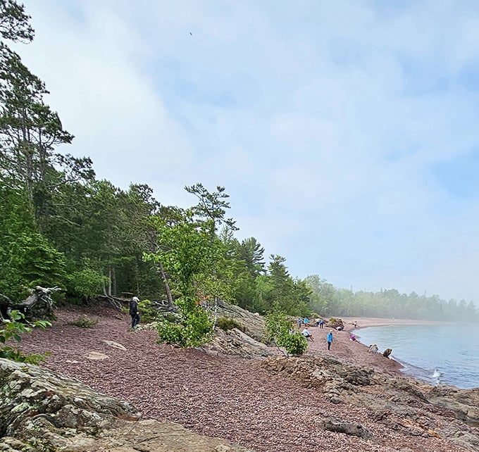 Agate Beach's rusty-hued shoreline isn't your typical sand experience—it's nature's rock tumbler, where Lake Superior has been polishing stones since the Ice Age.