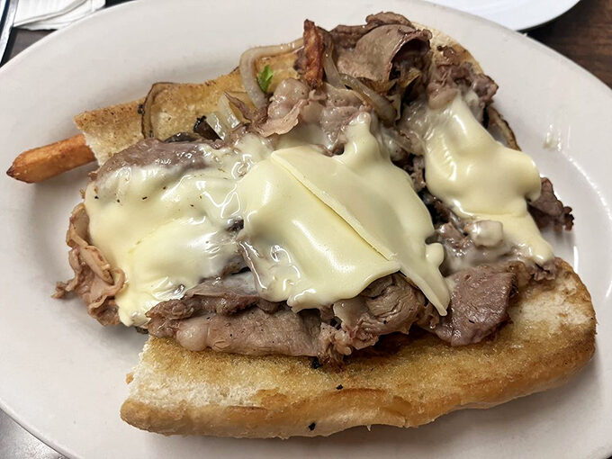 A French dip that's less about France and more about dipping into happiness. That melted cheese is performing magic tricks on perfectly seasoned beef.