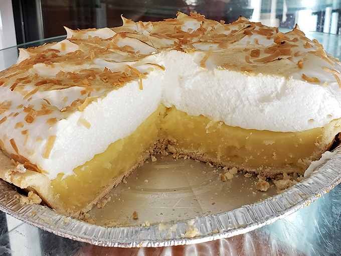 Coconut cream pie with a meringue so high it needs FAA clearance—the kind of dessert that makes diets seem like a terrible idea.