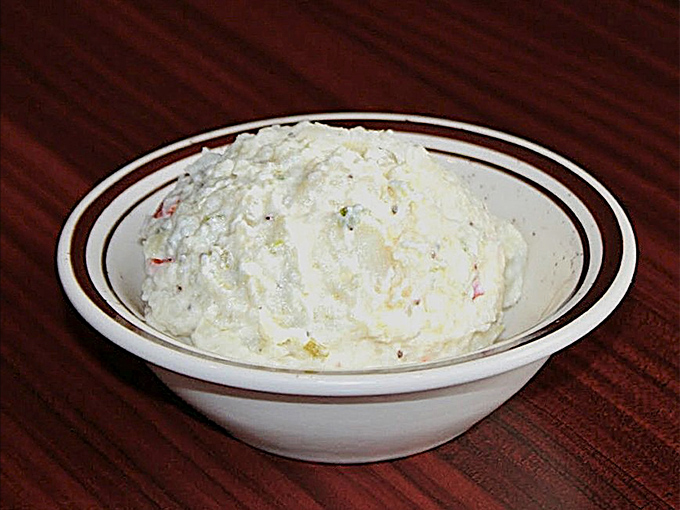 Potato salad arrives cool and creamy, providing that essential counterpoint to all the smoky, spicy heat on your plate.