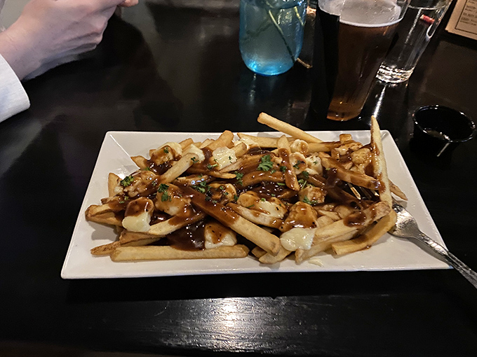 Poutine with a twist&mdash;these fries are swimming in gravy and cheese with such joy they don't realize they're being eaten.