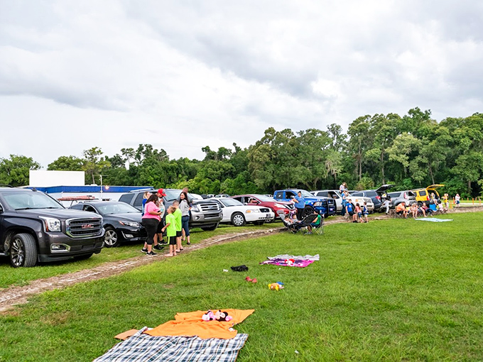 Early birds stake their claims with blankets and lawn chairs, creating their own little kingdoms of comfort before the feature presentation.