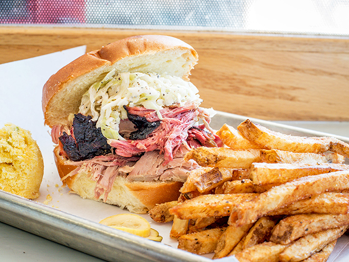 This pulled pork sandwich doesn't just whisper smokiness – it broadcasts it. The coleslaw provides the perfect cool counterpoint to meat that clearly took its time.