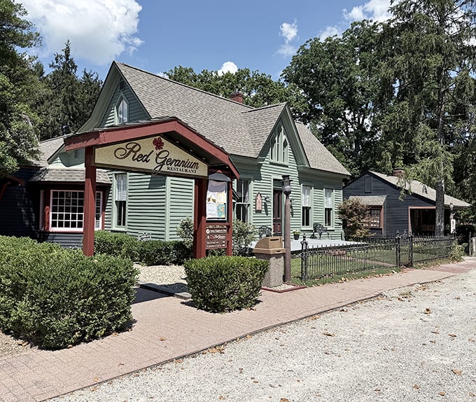 The Red Geranium Restaurant's charming cottage exterior promises home-style comfort with a dash of sophistication—Grandma's cooking in its Sunday best.