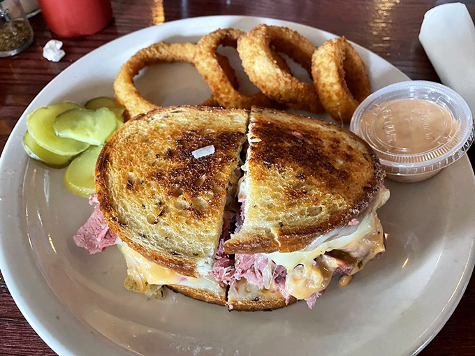 This Reuben sandwich has achieved perfect balance—crispy grilled bread, melty cheese, and a meat-to-sauerkraut ratio that would make a deli owner weep with joy.