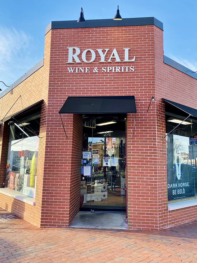 Royal Wine & Spirits stands guard at a corner like a brick sentinel protecting liquid treasures. The kind of local bottle shop where recommendations become revelations.