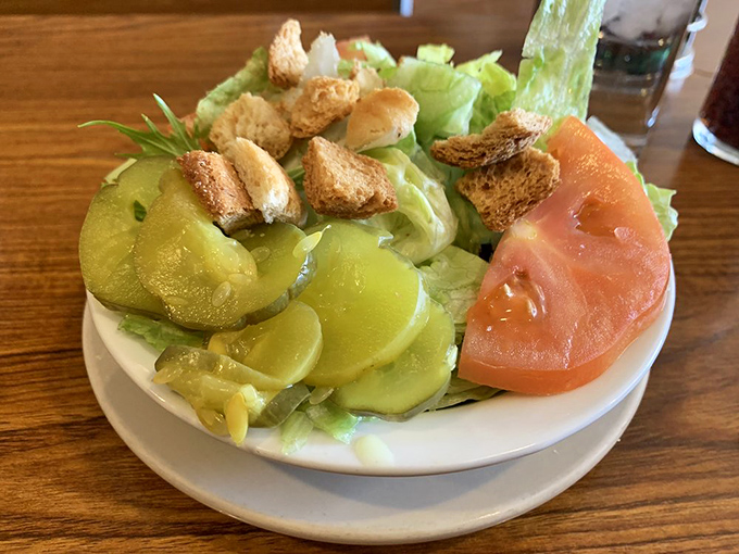 Even the side salad gets respect here. Crisp lettuce, thick-cut pickles, ripe tomatoes, and house-made croutons&mdash;simple ingredients treated with dignity.