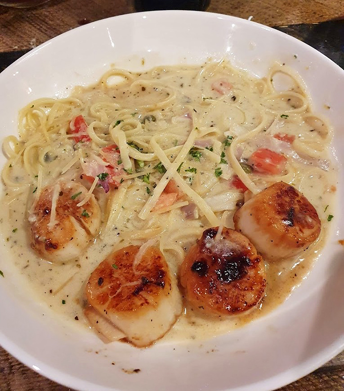 Scallops seared to golden perfection atop creamy pasta &ndash; proof that Nevada knows its seafood, even in cowboy country.