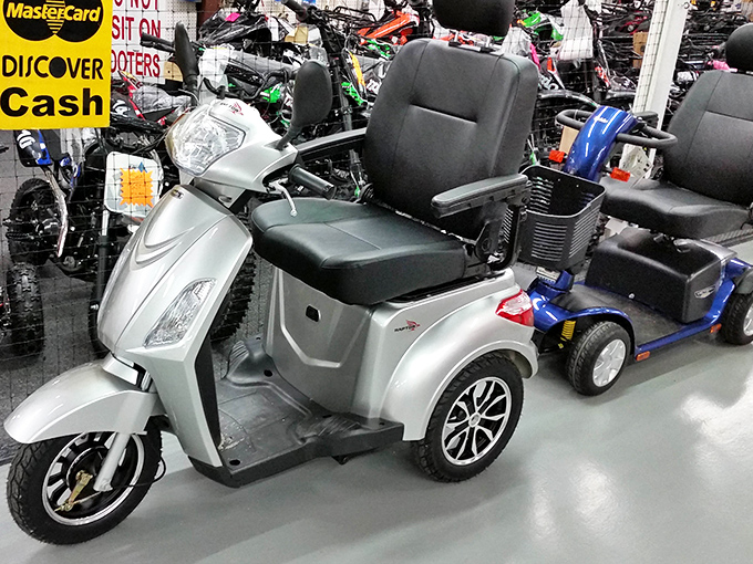 Modern mobility meets flea market practicality when even the scooters themselves become part of the eclectic inventory for sale.