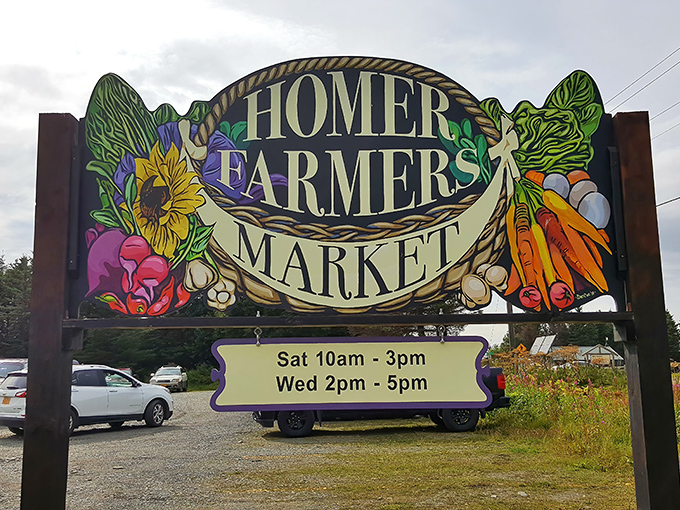 More than just a sign&mdash;it's a promise. The Homer Farmers Market's artistic entrance announces its hours while showcasing the colorful bounty waiting just beyond.