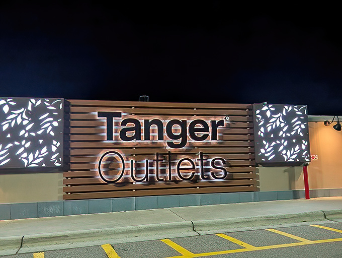Illuminated signage beckons night shoppers like a retail lighthouse. Follow the glow to find safe harbor for your fashion emergencies, even after sunset.