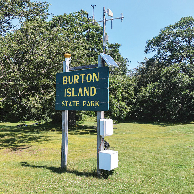 The island's entrance sign stands like a portal announcing you've officially left your worries on the mainland.