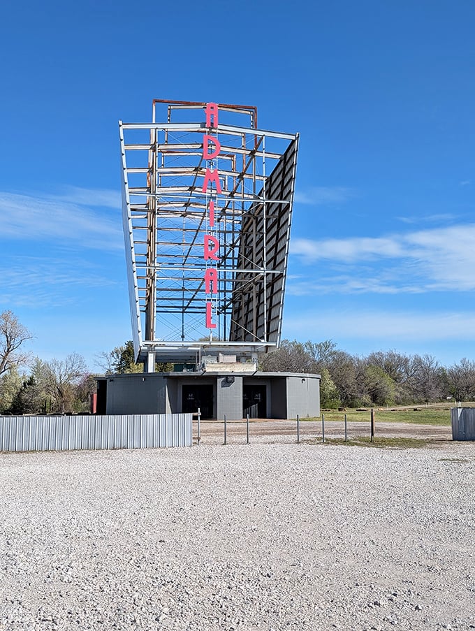 The towering ADMIRAL sign stands sentinel against blue skies, a vertical exclamation point announcing "movies happen here!"