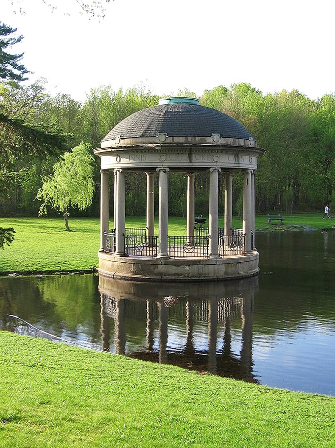 The classical gazebo at Slater Park creates a postcard-perfect scene, reflecting in the pond like something from a more genteel era.