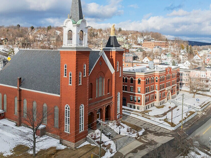 St. Ann's Church reaches skyward, its brick facade and soaring steeple anchoring the community in tradition and timeless beauty.