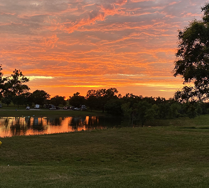 Sunset painting the sky like Mother Nature's been watching too many Bob Ross reruns &ndash; happy little clouds indeed.