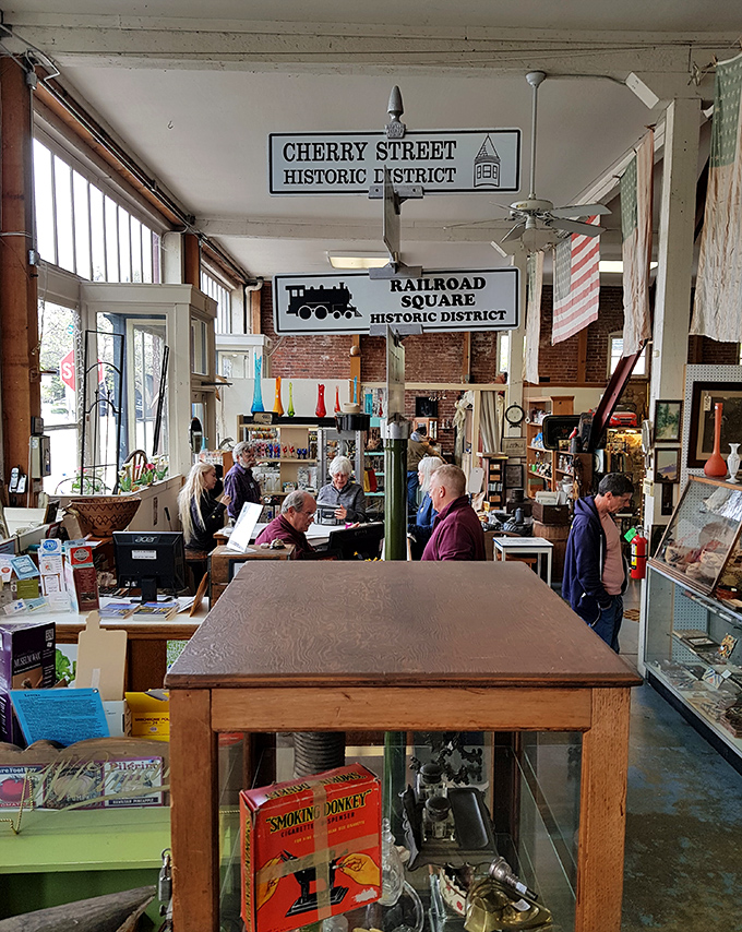 Where treasure hunters gather beneath historic district signs. The Railroad Square location adds another layer of charm to this antique-seeker's paradise.