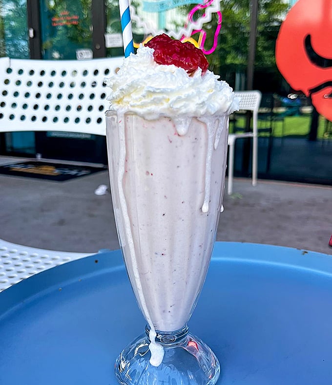 This isn't just a milkshake—it's a structural engineering marvel topped with enough whipped cream to make a dairy cow blush.