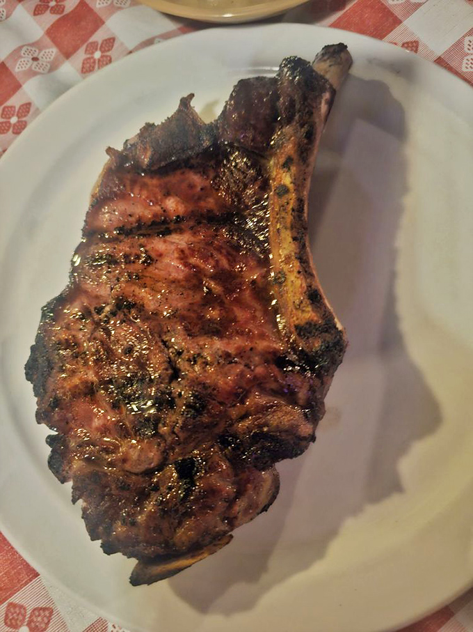 The T-bone steak arrives like a meaty monument to carnivorous pleasure. That sear isn't just cooking – it's a love letter written in flame.