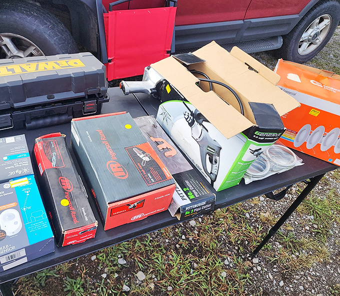 Power tools and equipment stacked like someone's garage finally admitted defeat and surrendered to the flea market gods.