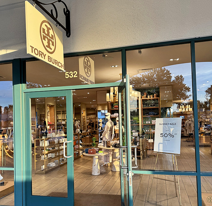 Tory Burch's elegant storefront showcases aspirational style at somewhat less aspirational prices. That 50% off sign is the real window display.