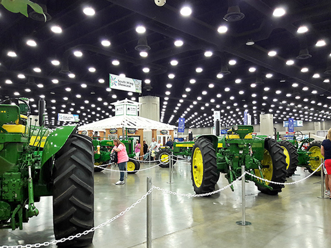 Green giants of agricultural history stand sentinel. These John Deere tractors plowed Kentucky fields long before GPS-guided farming was a thing.
