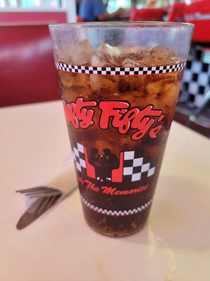 The checkered pattern wrapping this classic soda feels like a finish line flag for your thirst. Bubbles dancing in amber liquid&mdash;simple perfection.